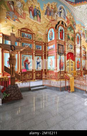 The iconostasis decorated with icons and religious paintings inside the church of the Greek ...