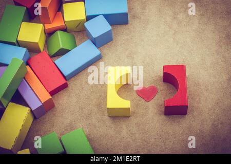 Heart shape placed between building blocks Stock Photo - Alamy