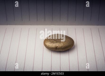 Little gold color stone on with a background Stock Photo - Alamy
