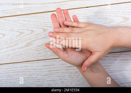 Hands making a gesture on a wooden background Stock Photo - Alamy