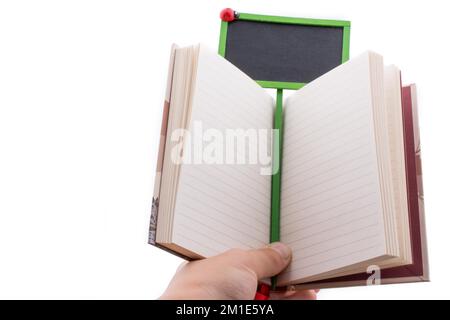 Hand holding a spiral notebook and a notice board Stock Photo - Alamy