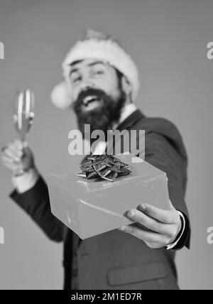 Businessman with cheerful face holds present box and red decor Stock ...