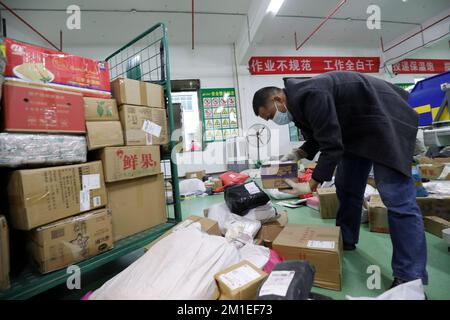 CHENZHOU, CHINA - DECEMBER 12, 2022 - Staff members sort express ...