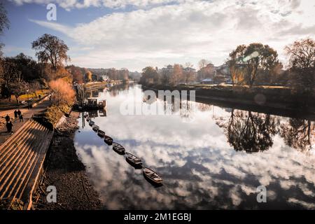 Beautiful view of rowboats moored in line on the River Thames on a cold ...