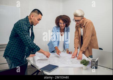 Multinational architectural team working on a site development plan ...