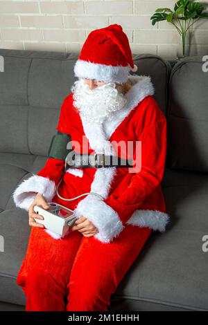 Santa is sick and not feeling well. Santa measures blood pressure Stock ...