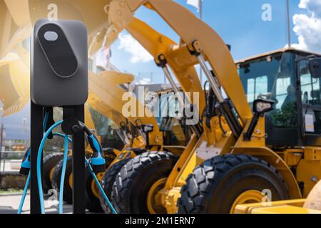 Electric construction machines with charging station. Concept Stock ...