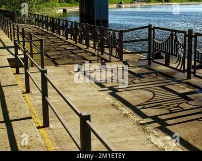 river embankment made of concrete slabs on a clear day, in summer Stock ...