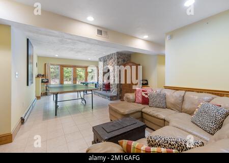 An interior shot of a room with a ping pong table, light yellow walls ...