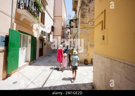 Family of tourists waking in streets Bari, Puglia, South Italy Stock ...