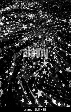 Collapsing sparkly universe in silver wrinkling paper with sky and ...