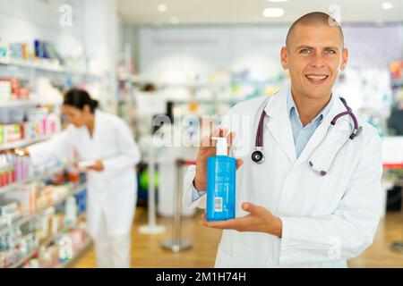 Male pharmacist offers various body care medicines Stock Photo - Alamy