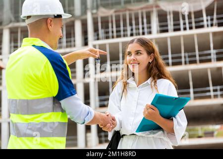 Young male contractor and female customer in moving concept Stock Photo ...
