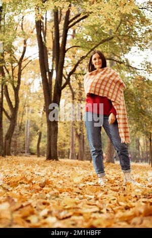 Woman with autumn leaves of maple trees. Woman near autumn fall leaves ...