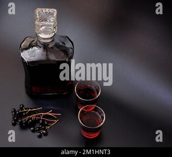 Cherry liquor and ripe juicy berries on a brown table Stock Photo - Alamy