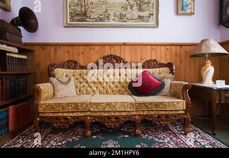 Gold upholstered Rococo style sofa in parlor room inside old 1904 ...