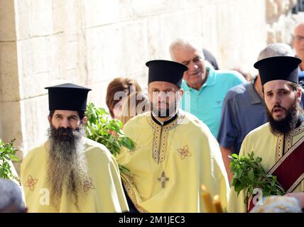 Greek Orthodox priests and nuns walking in a procession from the Tomb ...