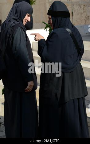 Orthodox Christian nuns gather before the start of a procession from ...