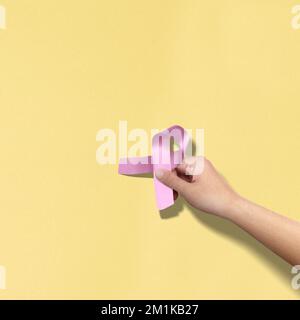 Human hand holding purple ribbons with a black background. World Cancer ...