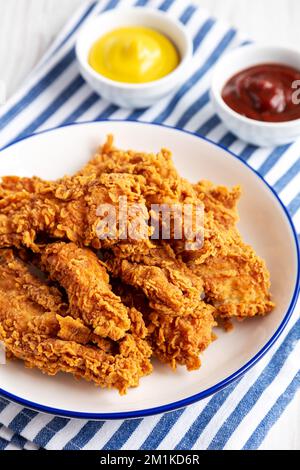 Homemade Chicken Strips with Mustard and BBQ on a Plate on a black ...