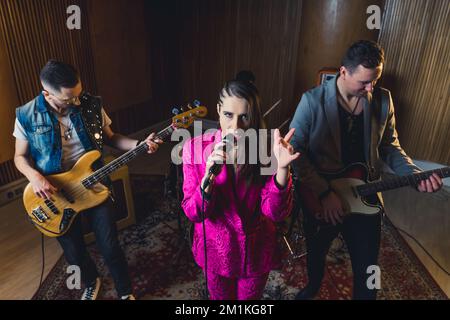 High angle shot of four band members sitting next to note sheets on a ...