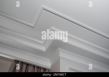 Detail of corner ceiling with intricate crown molding on column with ...