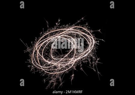 light chain made from sparkler at night, black background, isolated ...