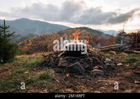 Bowler cooking food bonfire cauldron camp fire, pot. Hiking pot in the ...