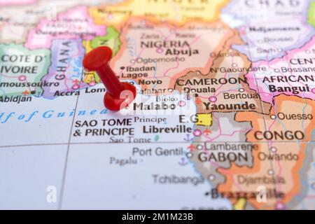 Close up to a Malabo city with a red pin needle into Equatorial Guinea ...
