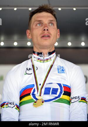 Tony Martin celebrates on the podium with his gold medal after winning ...