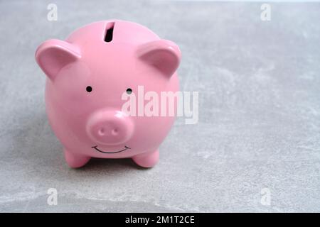 Pink piggy bank light concrete background Stock Photo - Alamy