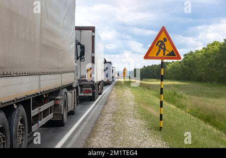 Trucks are stuck in traffic. A column of semi-trailers on the freeway ...