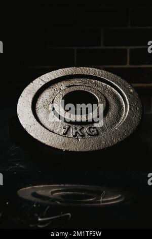 A vertical shot of a 2 kg metal plate Stock Photo - Alamy