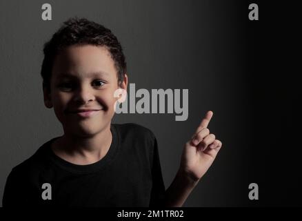 child pointing and reaching up to the sky on white background with ...