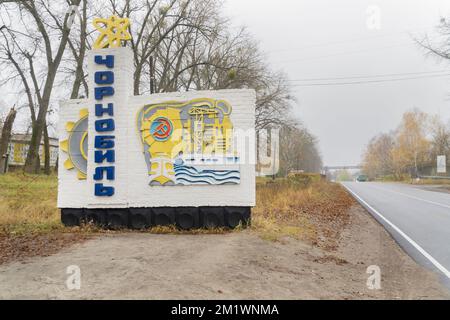 Old lettering chernobyl town entrance sign near to an asphalt road ...