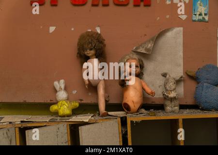 Two dolls over a rusty bed inside an abandonated kinder garden at ...