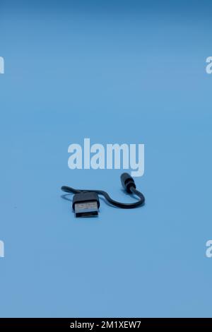 A vertical shot of type A to Micro USB cable on a blue background Stock ...