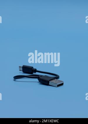 A vertical shot of type A to Micro USB cable on a blue background Stock ...