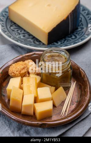 Cheese tasting, small pieces of old Dutch hard cheese and bowl with ...