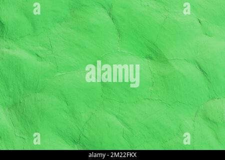 Green verdant light salad color paint on concrete surface stone wall ...