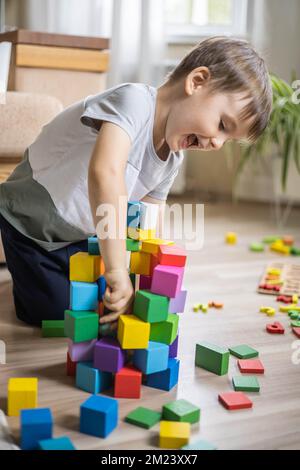 Confident male kid building fortress tower architecture and forest with ...
