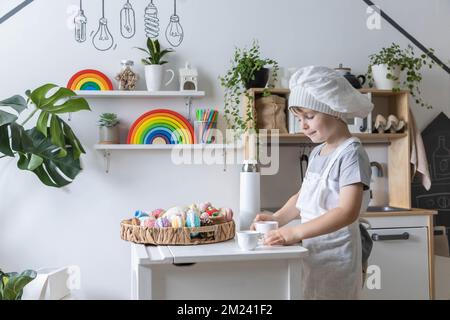 Portrait smiling male kid cafe chef posing with tray full sweet ...