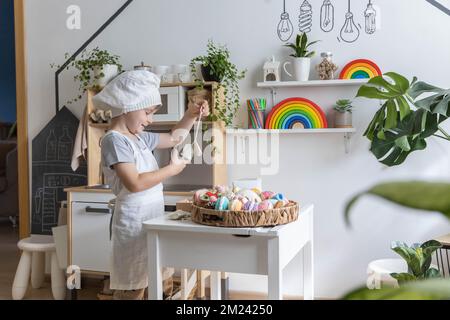 Portrait smiling male kid cafe chef posing with tray full sweet ...