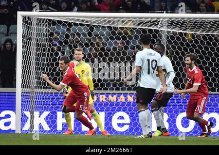 Belgium's goalkeeper Simon Mignolet and Russia's Viktor Vasin fight for ...