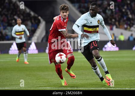 Belgium's Christian Benteke and Russia's Roman Neustadter fight for the ...