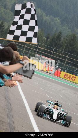 Mercedes driver Lewis Hamilton crosses the finish line to win the ...