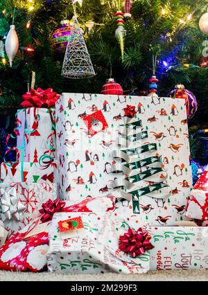 Beautifully wrapped gift boxes under Christmas tree indoors Stock Photo ...
