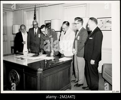 Col. Kellogg signing document , Ordnance industry, Armories, Gates ...