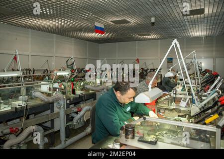A worker polishes a raw diamond in the ALROSA diamond factory, on the ...