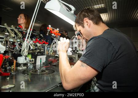 A worker polishes a raw diamond in the ALROSA diamond factory, on the ...